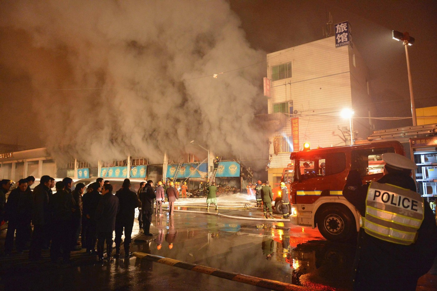 Firefighters try to extinguish a fire at a farm produce wholesale ...