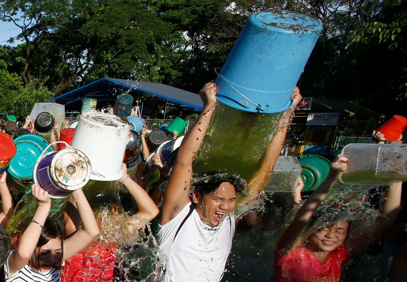 Filipino residents dump buckets of ice water on themselves as they take ...