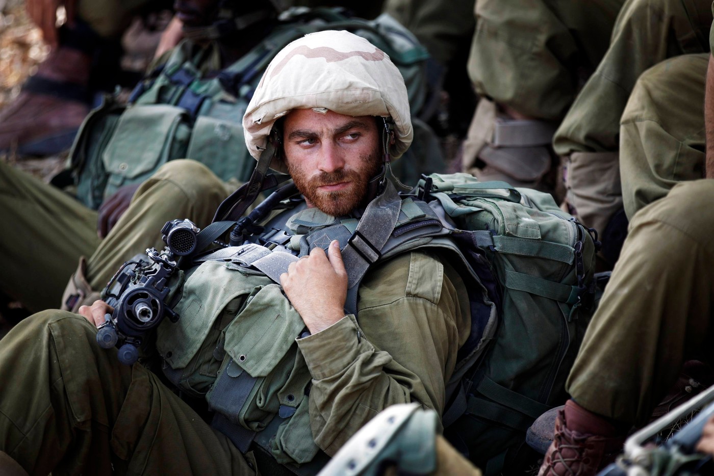 Israeli soldiers from the Nahal Infantry Brigade rest in the shade of ...