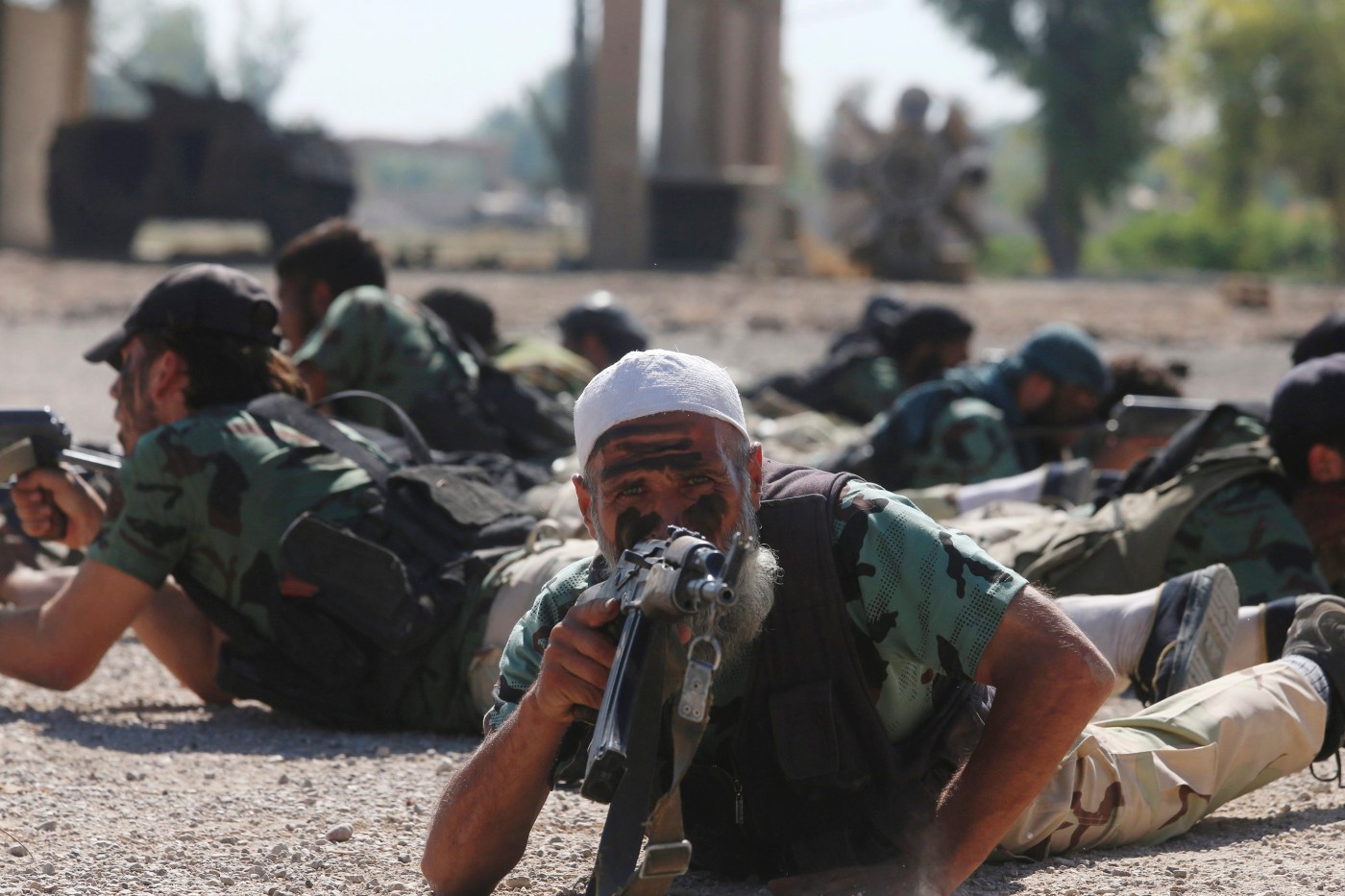 A rebel fighter aims his weapon during a military display as part of a ...