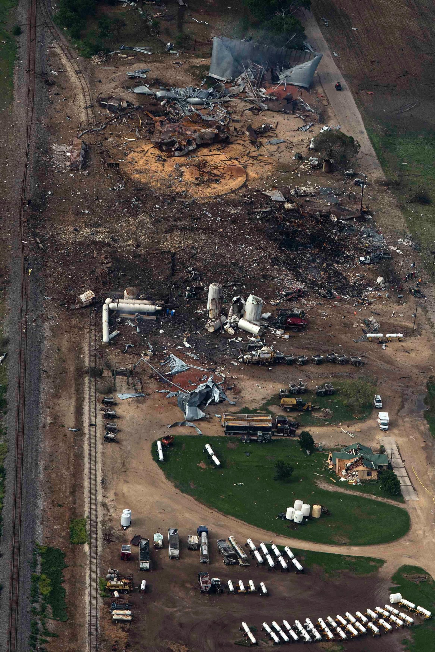 An aerial view shows investigators standing amid the aftermath of a ...