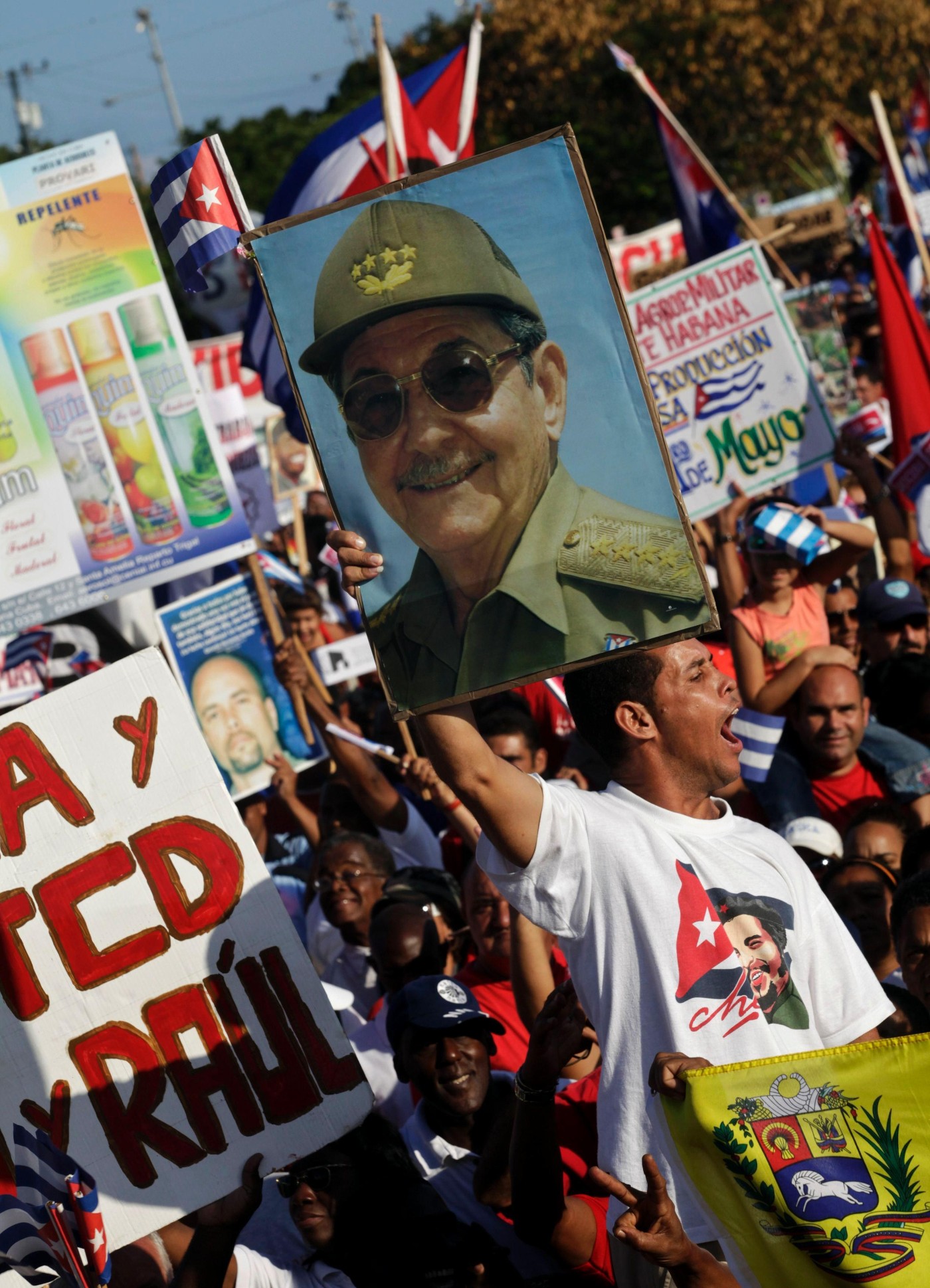 A man holds a picture of Cuba's President Raul Castro during the May ...