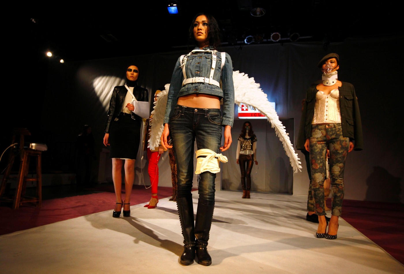 Models pose on a make-shift catwalk during a fashion show organised by ...