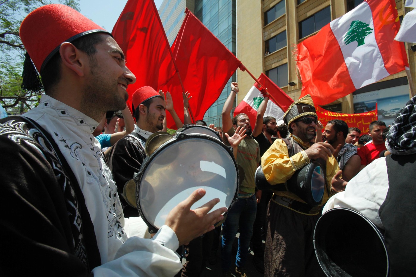 Lebanese leftist activists wave Lebanese and communist flags as they ...