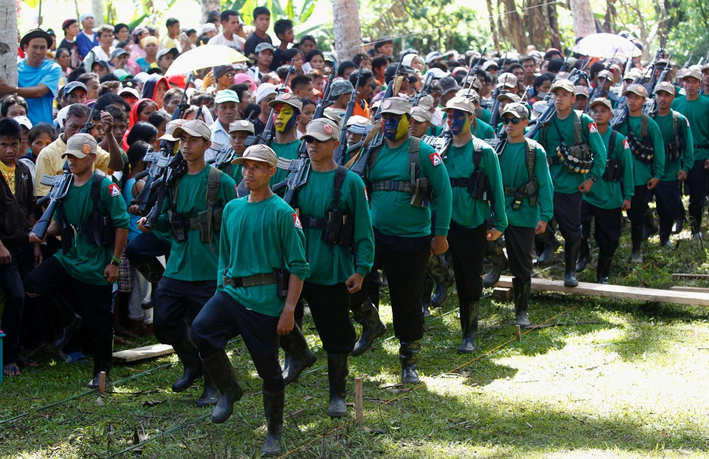 Filipino communist rebels march during the celebration of the 42nd ...