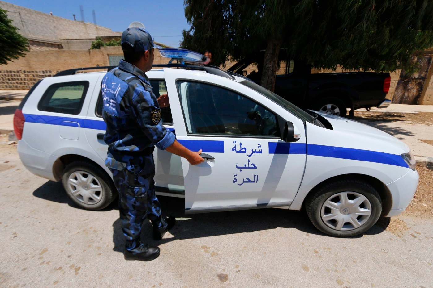 A Free Syrian Army policeman opens the door of a police vehicle in Kel ...