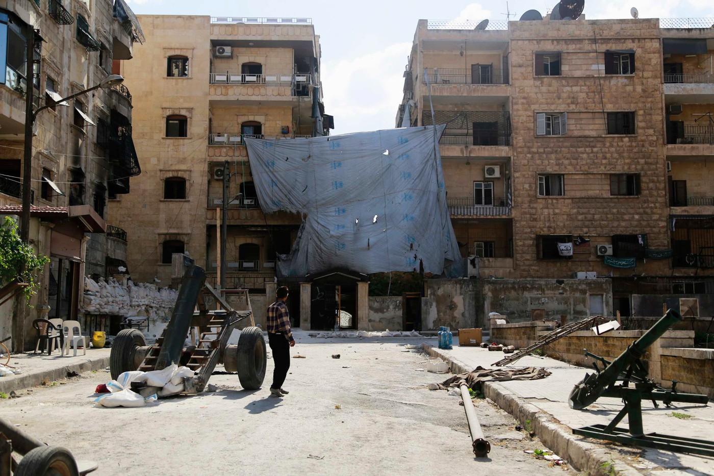 A Free Syrian Army fighter stands next to mortar launchers in Aleppo