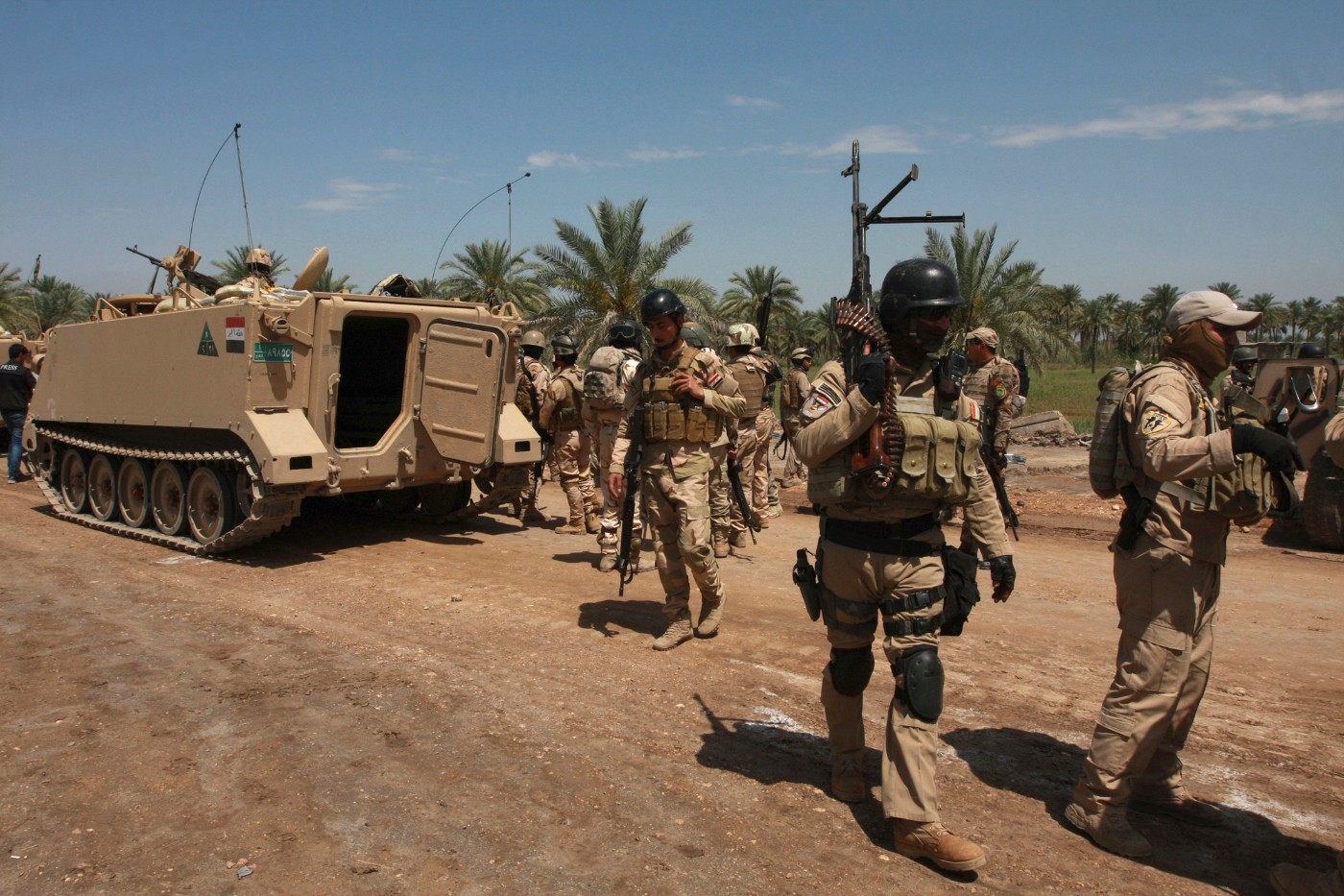 Personnel from Iraqi security forces take part in clashes with the al ...
