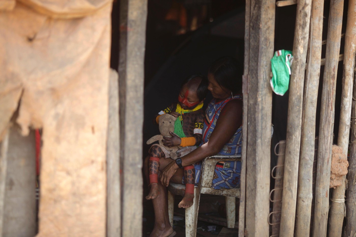 A woman from Kayapo tribe holds her kid inside her house on the second ...
