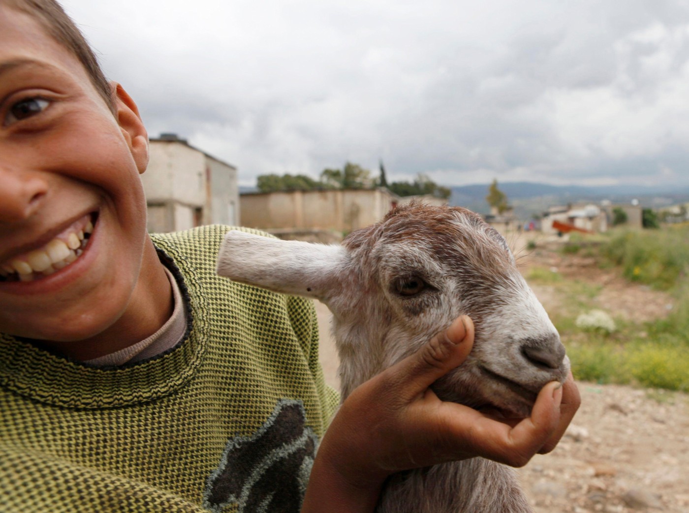 A Lebanese shepherd holds his goat in Wadi Khaled area, northern Lebanon