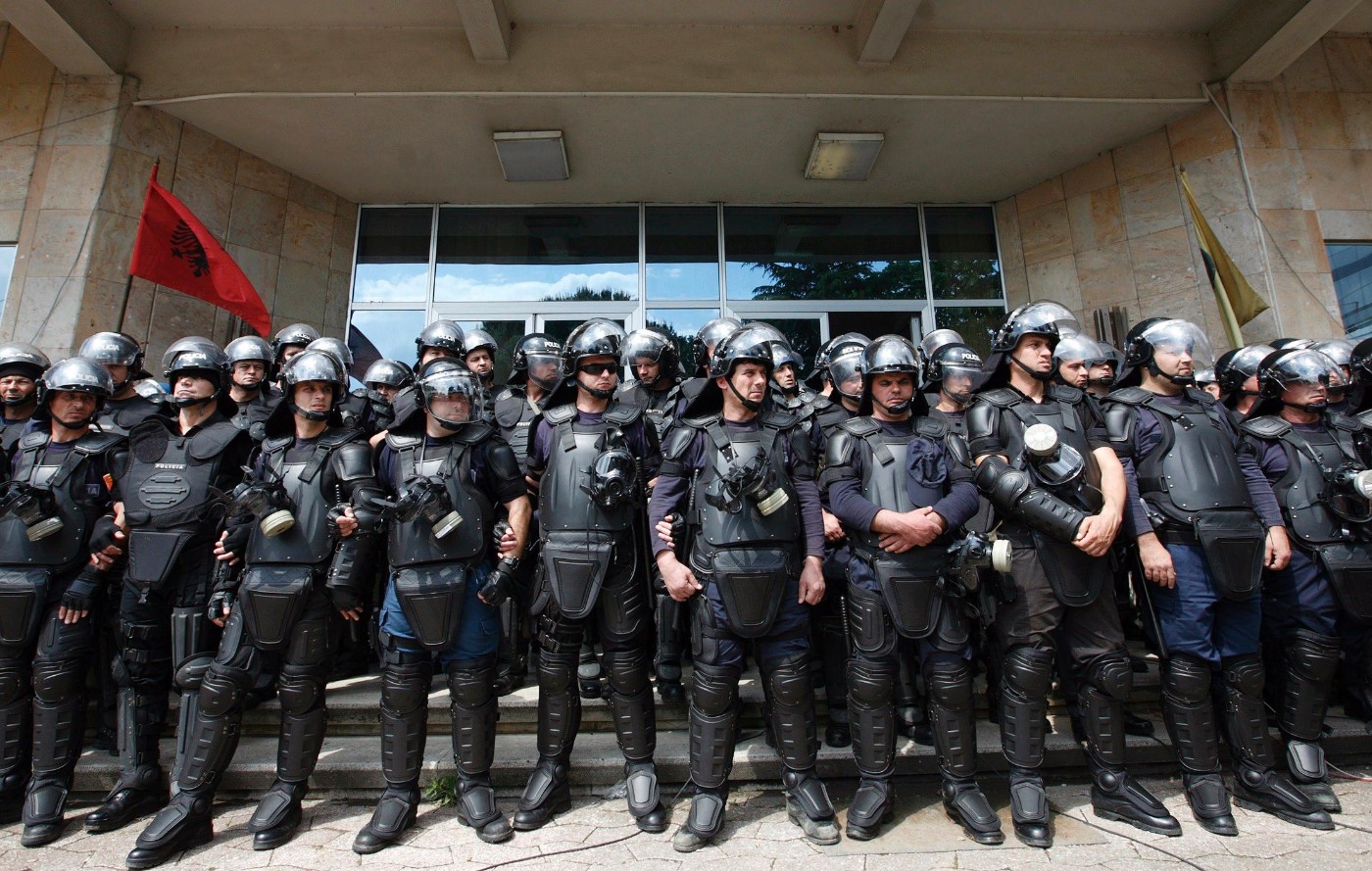 Albanian police stand guard at the entrance of the Central Election ...