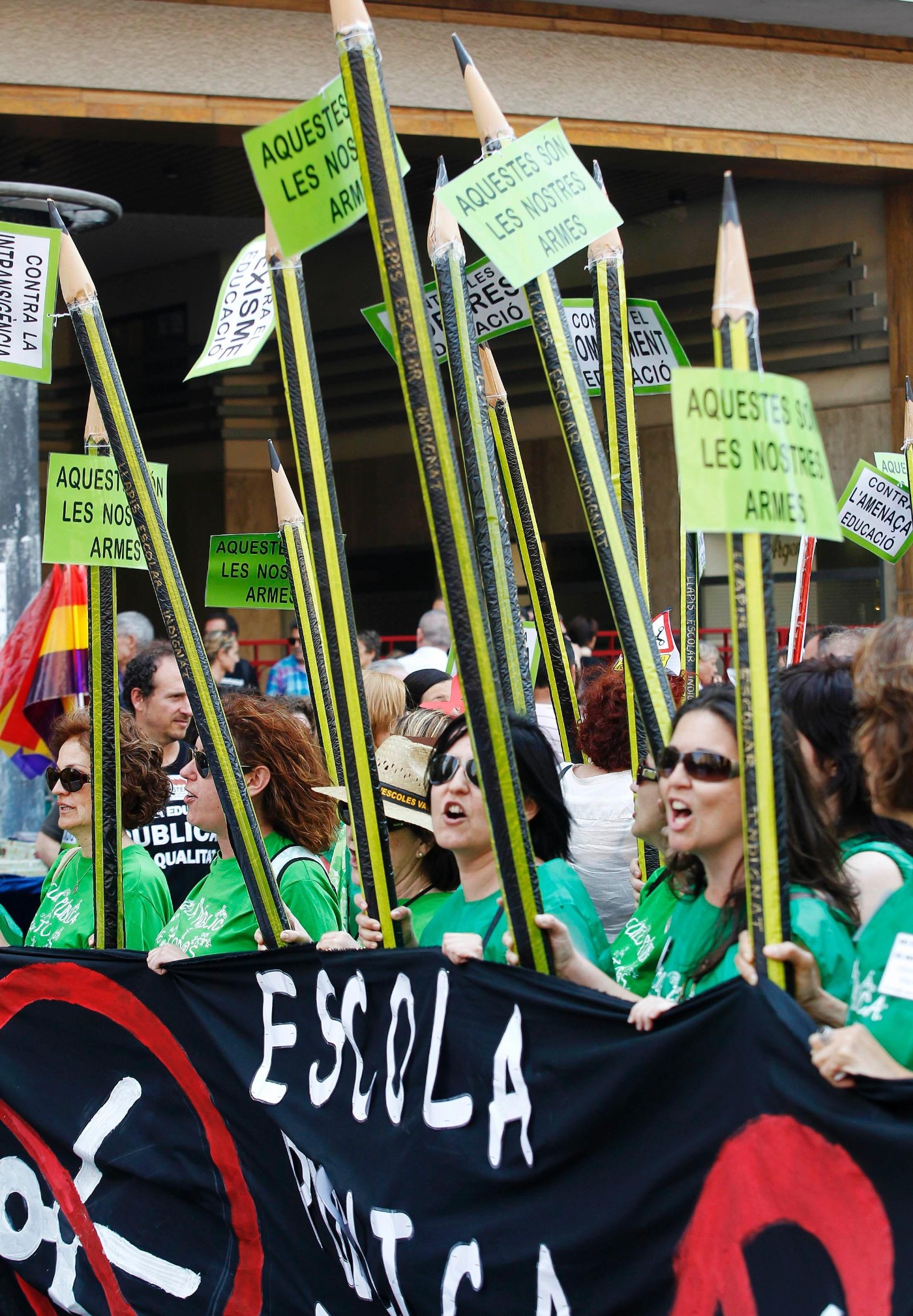 Protesters march with giant pencils during a strike staged by teachers ...