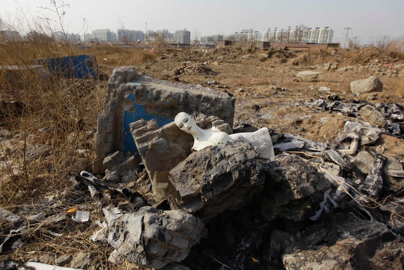 A discarded plastic mannequin and construction waste are placed next to ...