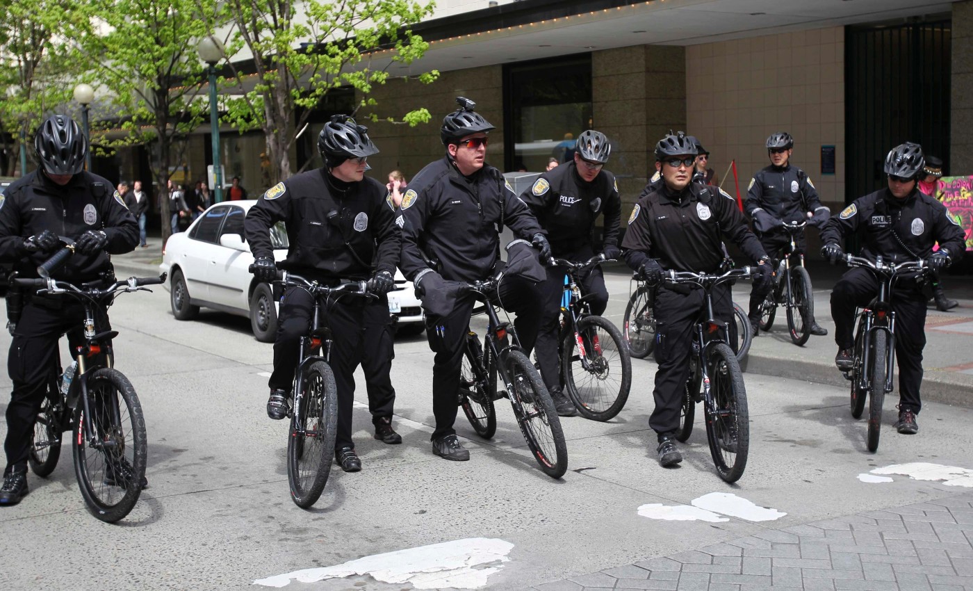 Police bicycle patrol officers escort a demonstration march through ...