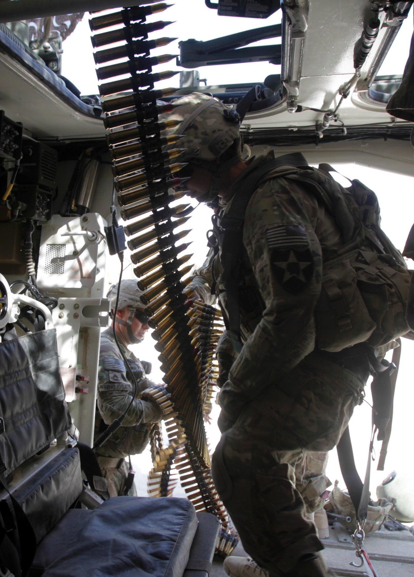 U.S. Army soldiers unload machine gun bullets from an armoured vehicle ...