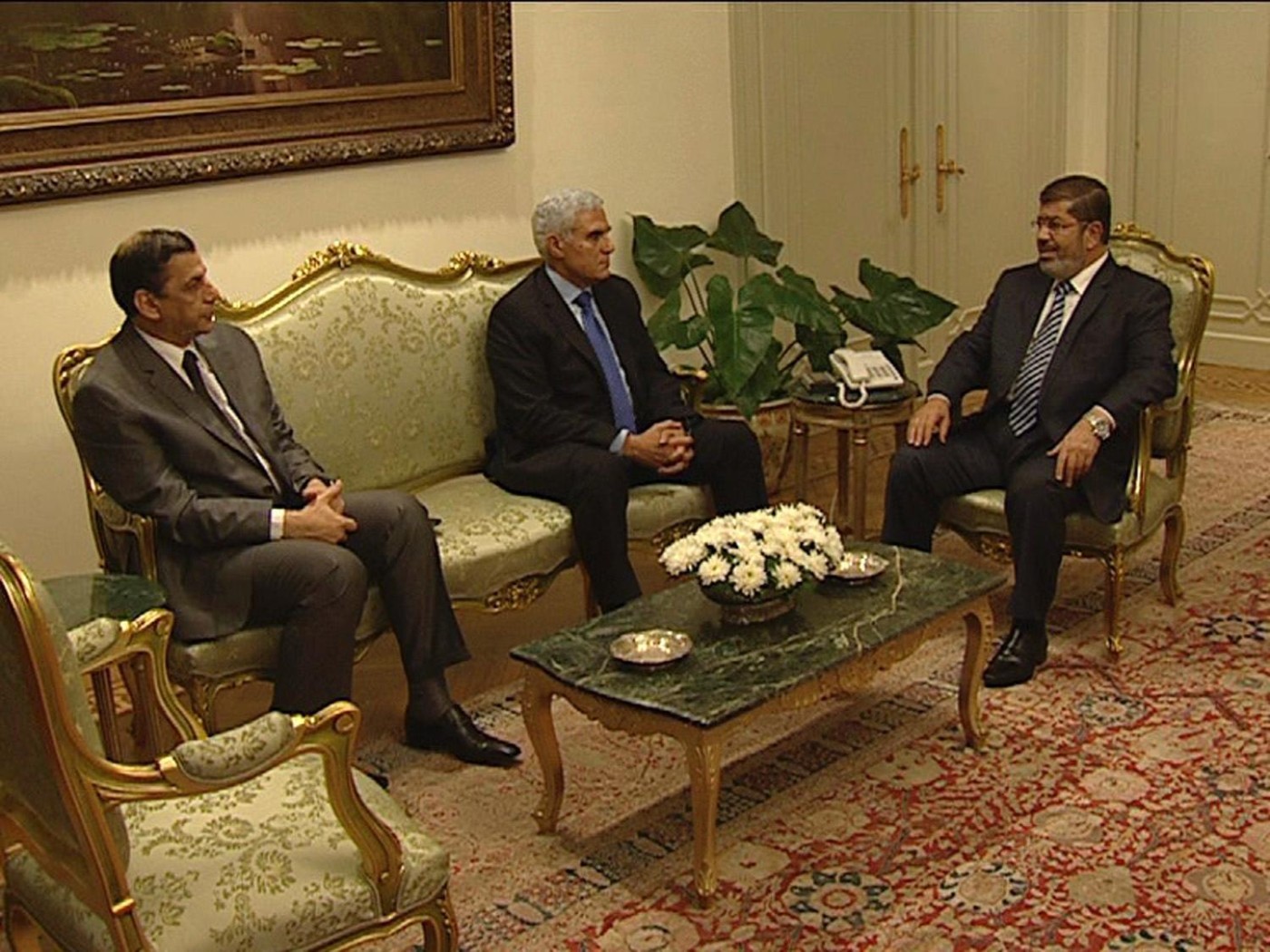Egypt's President Mohamed Mursi speaks with his Chief Intelligence ...