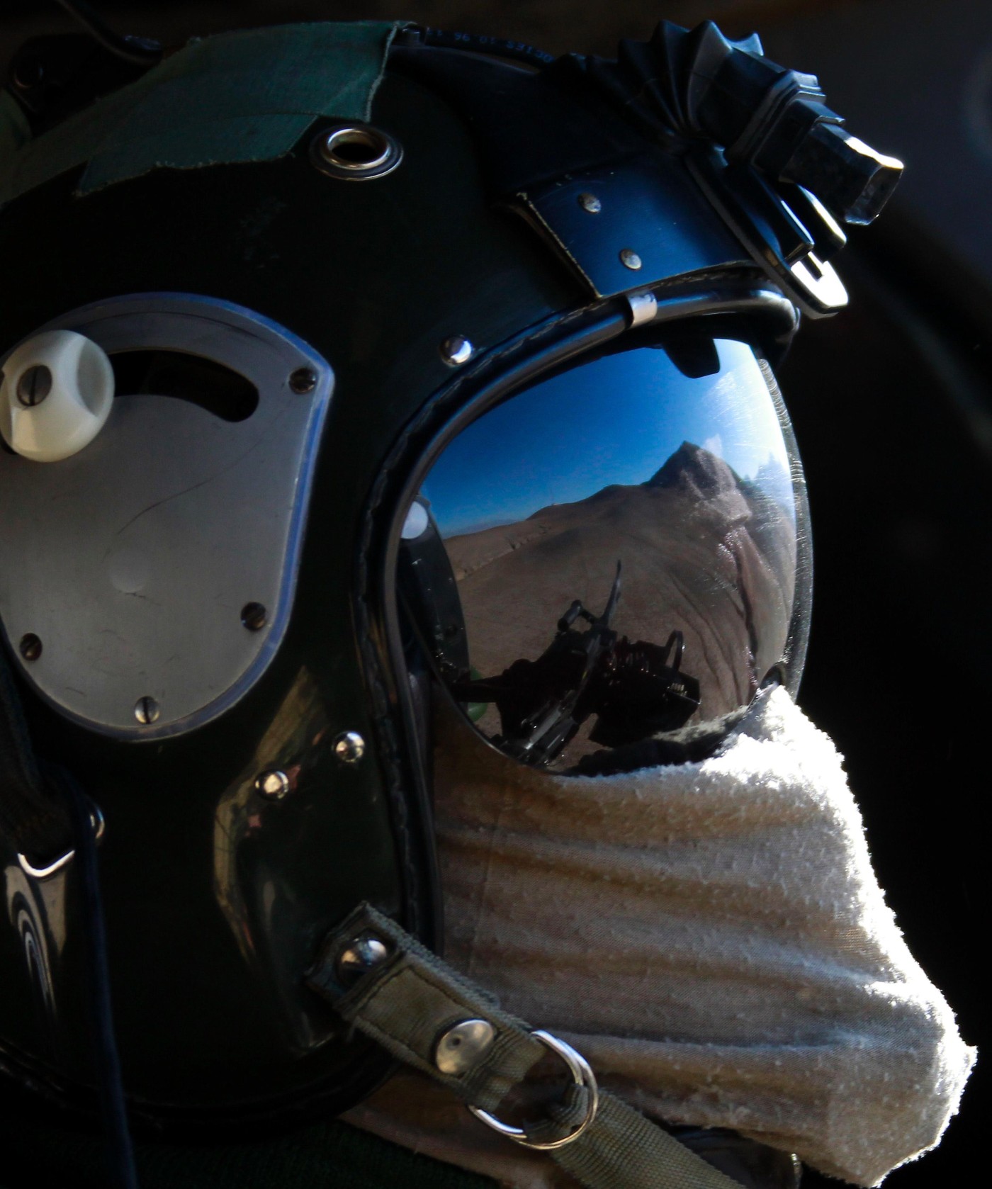 The machine gun of a French gunner is reflected on the visor of his ...