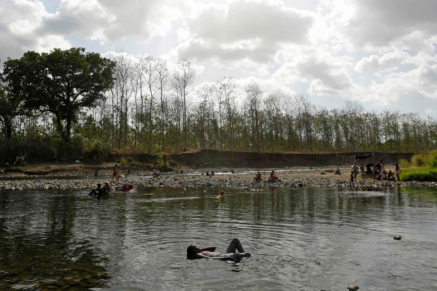 A woman relaxes in the waters of Pacora River, on the outskirts of ...