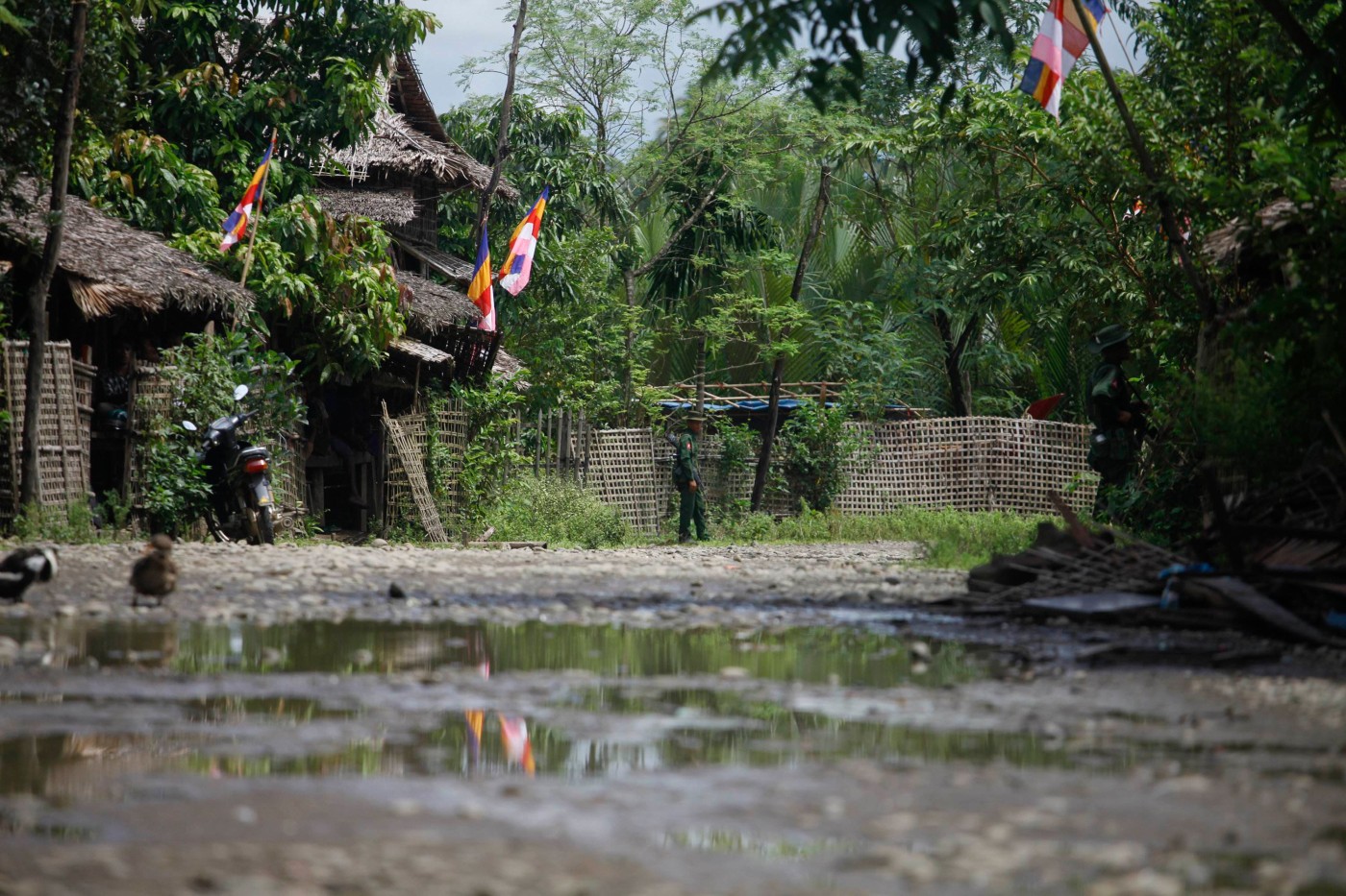 Sasana flags are seen at Buddhist homes in Thapyuchai village, outside ...