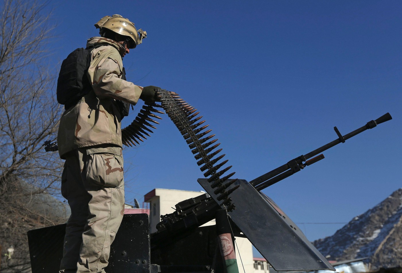 An Afghan Crisis Response Unit soldier prepares a machine gun for fire ...