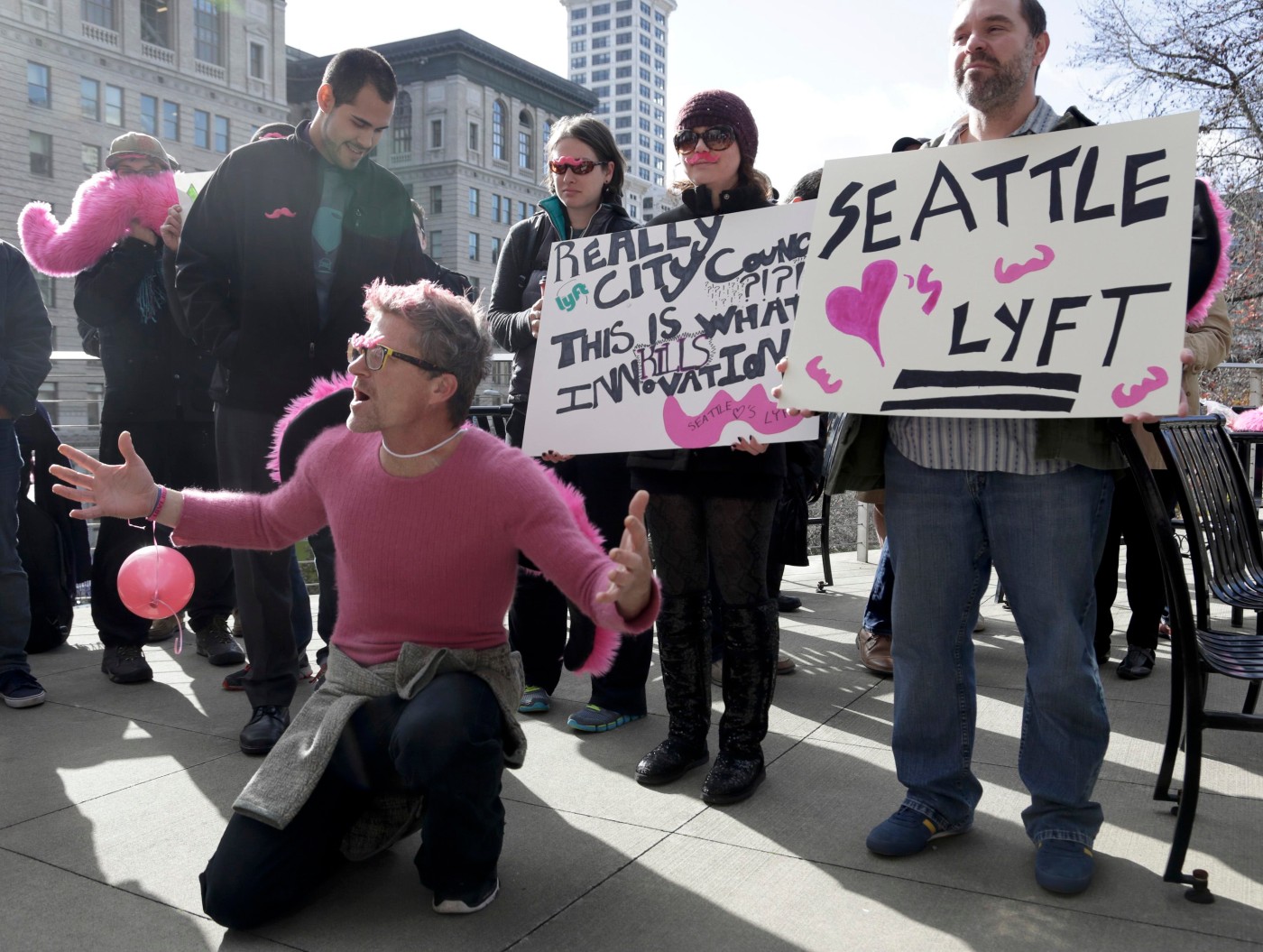Jeff Landon shows his support as Lyft ride-sharing supporters rally at ...