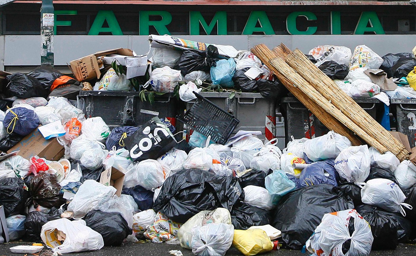Uncollected garbage is seen in front of an pharmacy in central Naples