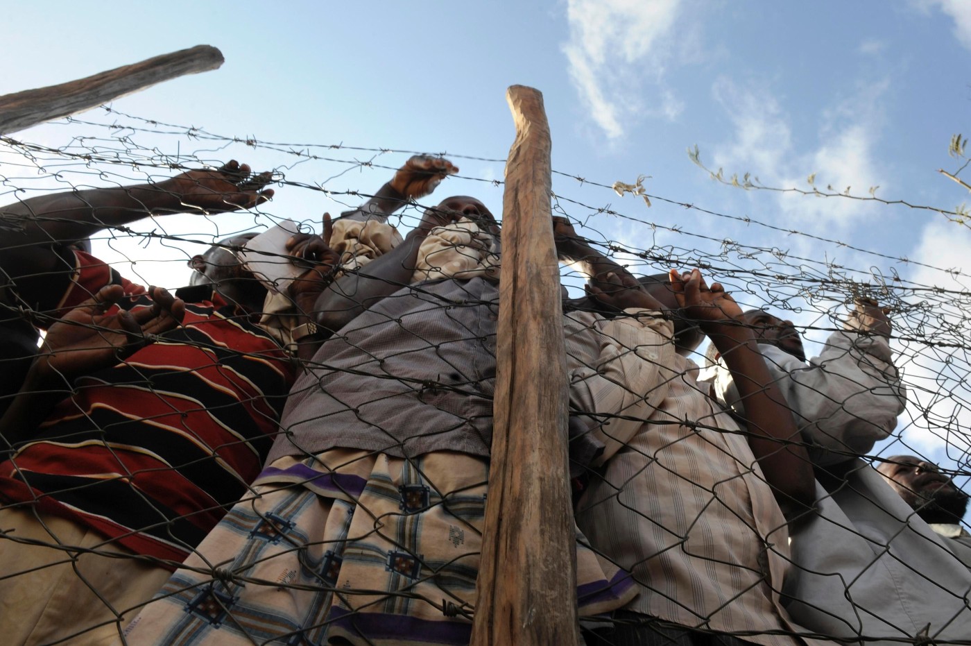 Refugees ask to be seen at the Hagadera reception center at Kenya's ...