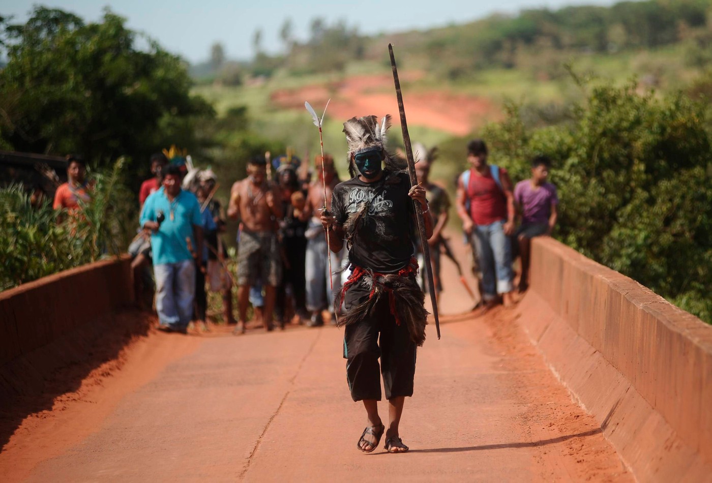 Members of the Guarani Nandeva tribe stand guard at the entrance to one ...