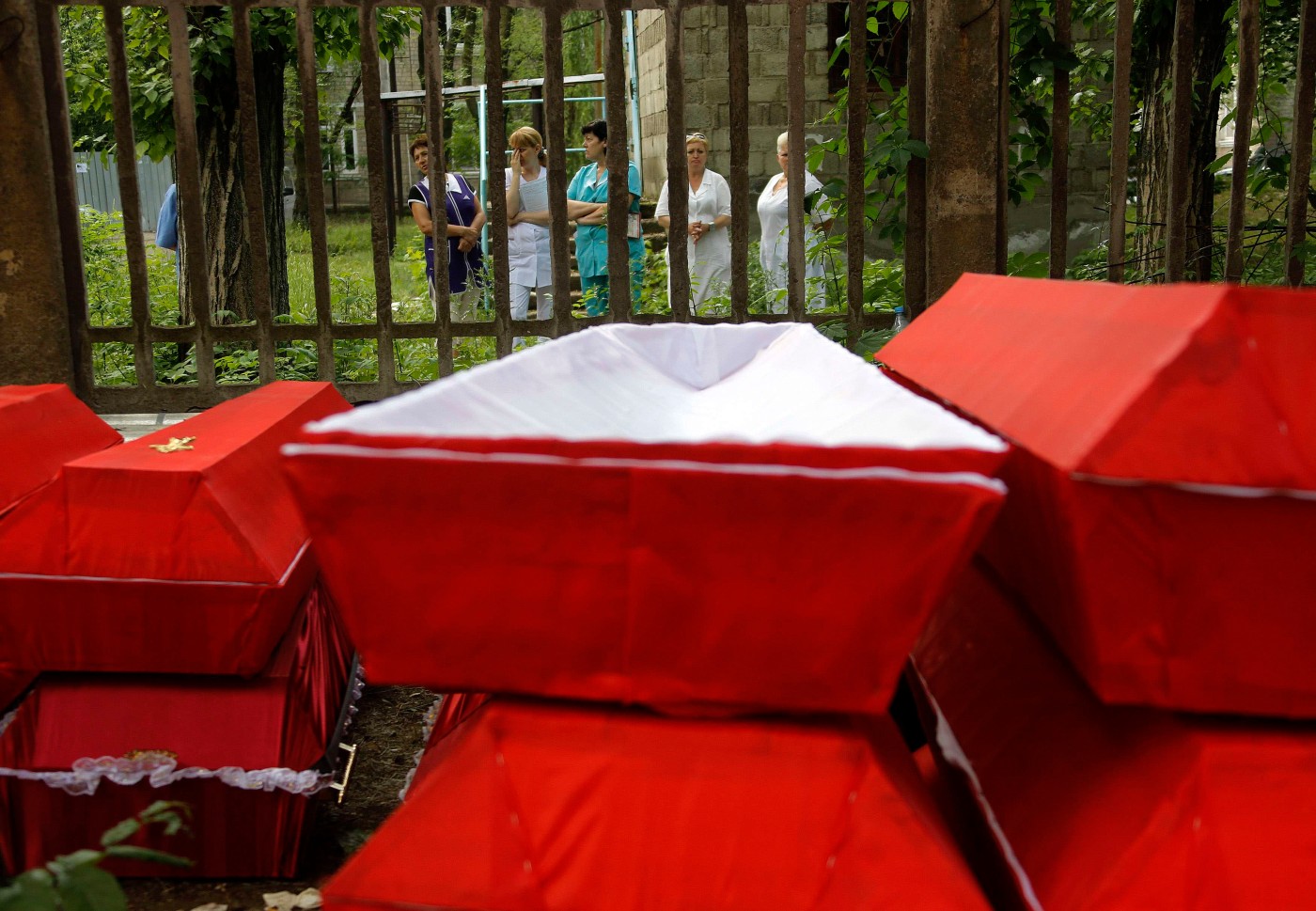 Medics look at thirty coffins prepared for the funerals of pro-Russian ...