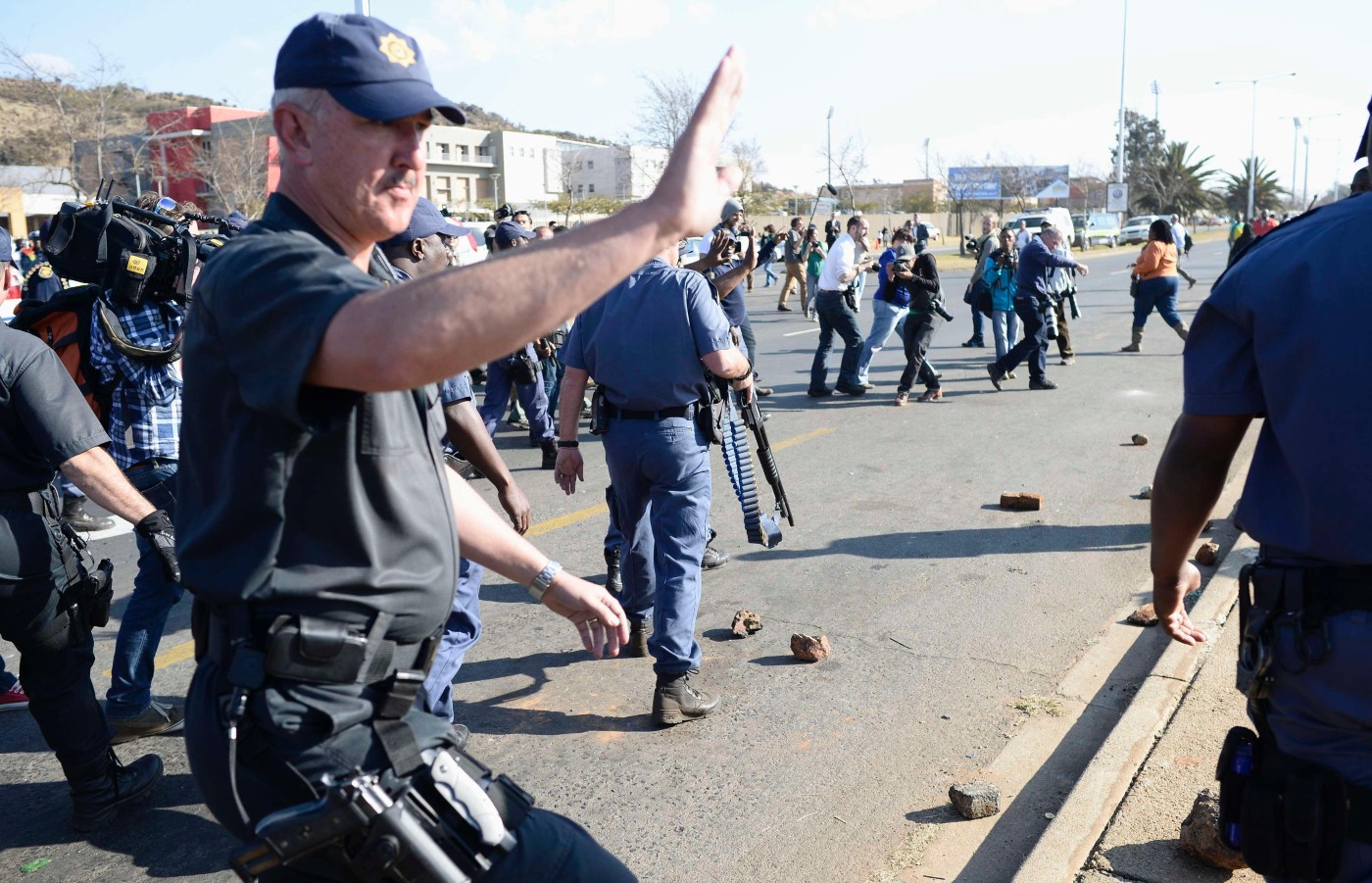 Police officers attempt to disperse protesters outside the University ...
